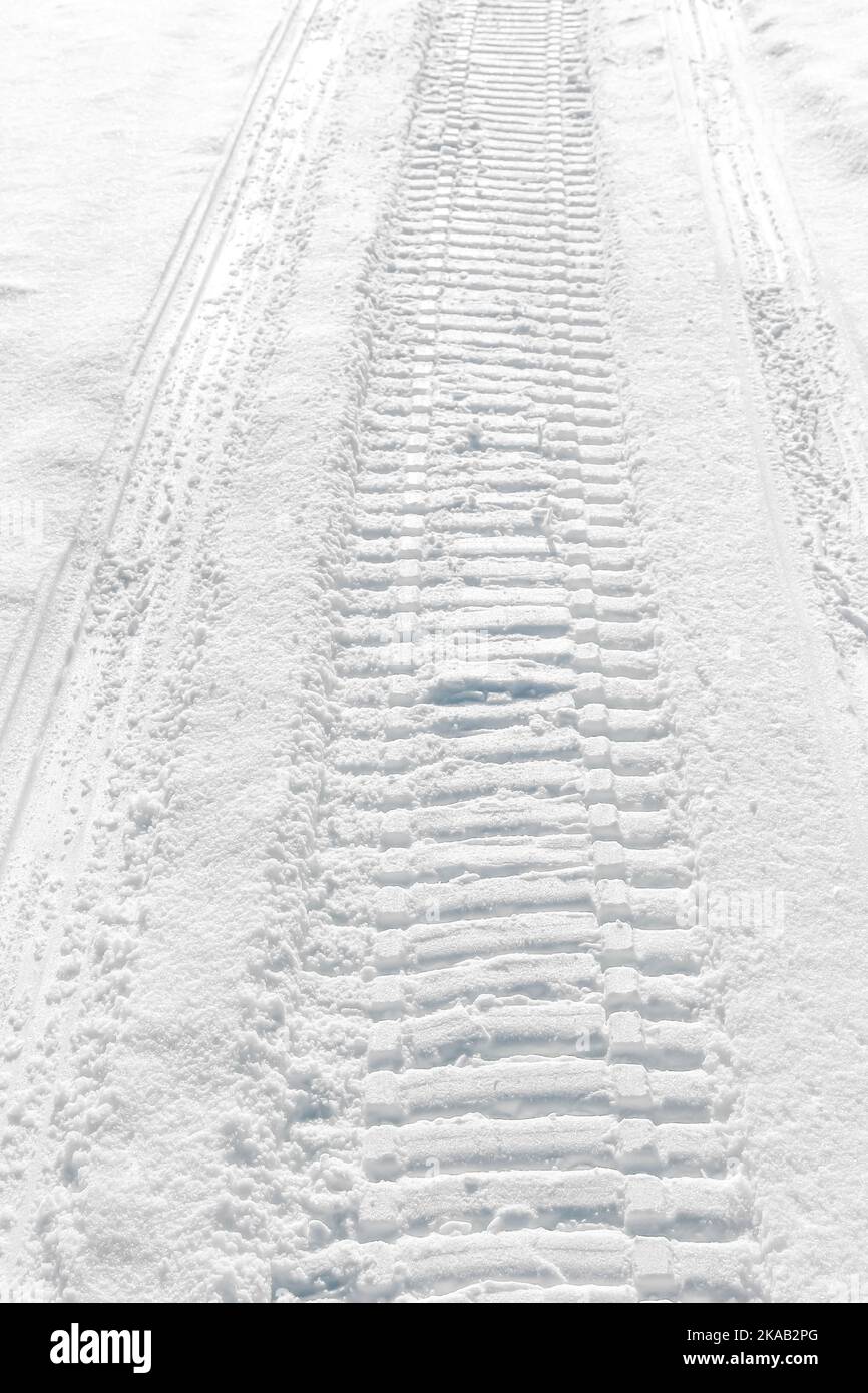 Trail of snow scooter wheel in fresh snow Stock Photo - Alamy