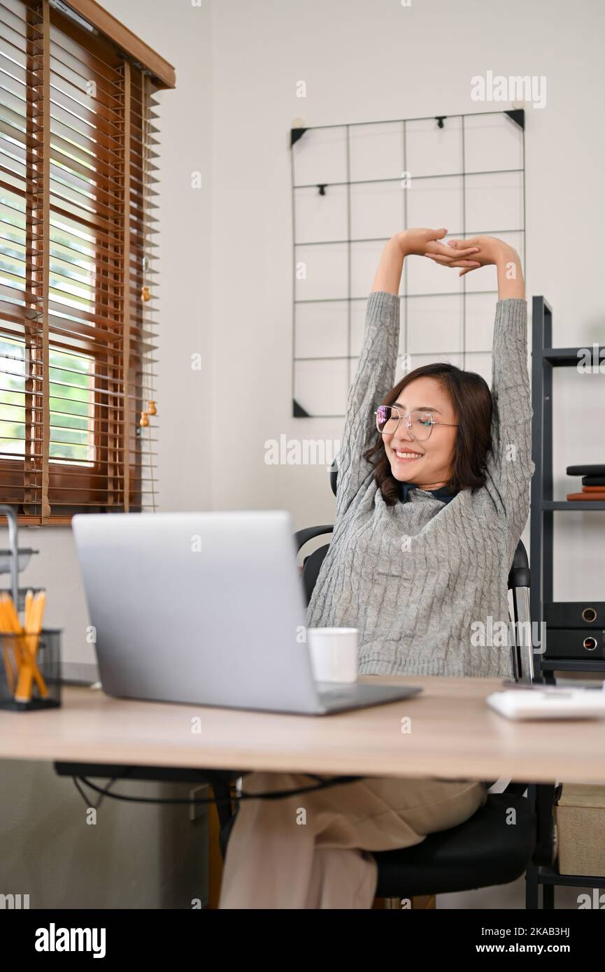 Portrait, Happy and smiling young Asian businesswoman stretching her ...