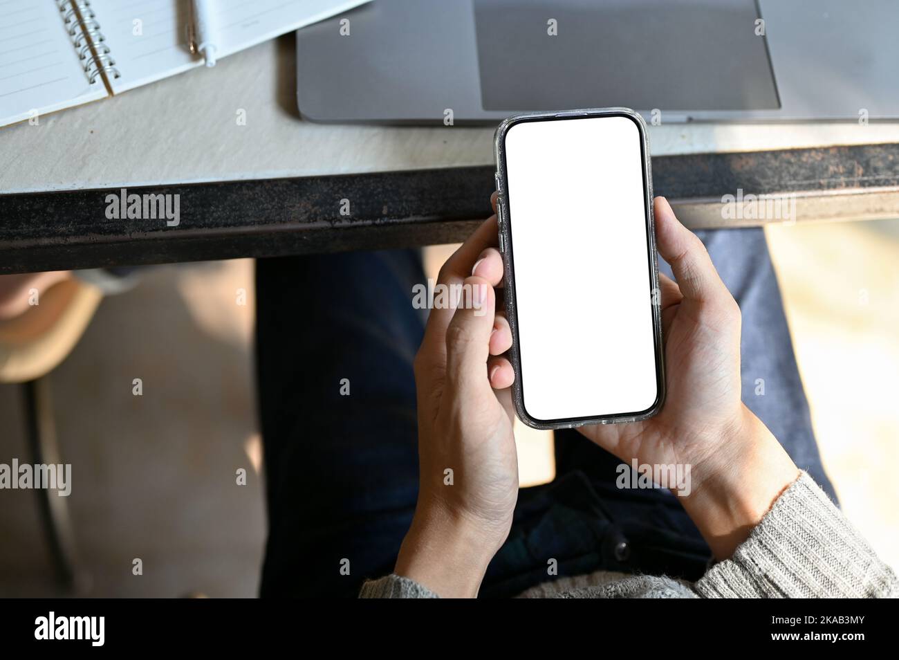 Top view image, A male hands holding a smartphone white screen mockup ...
