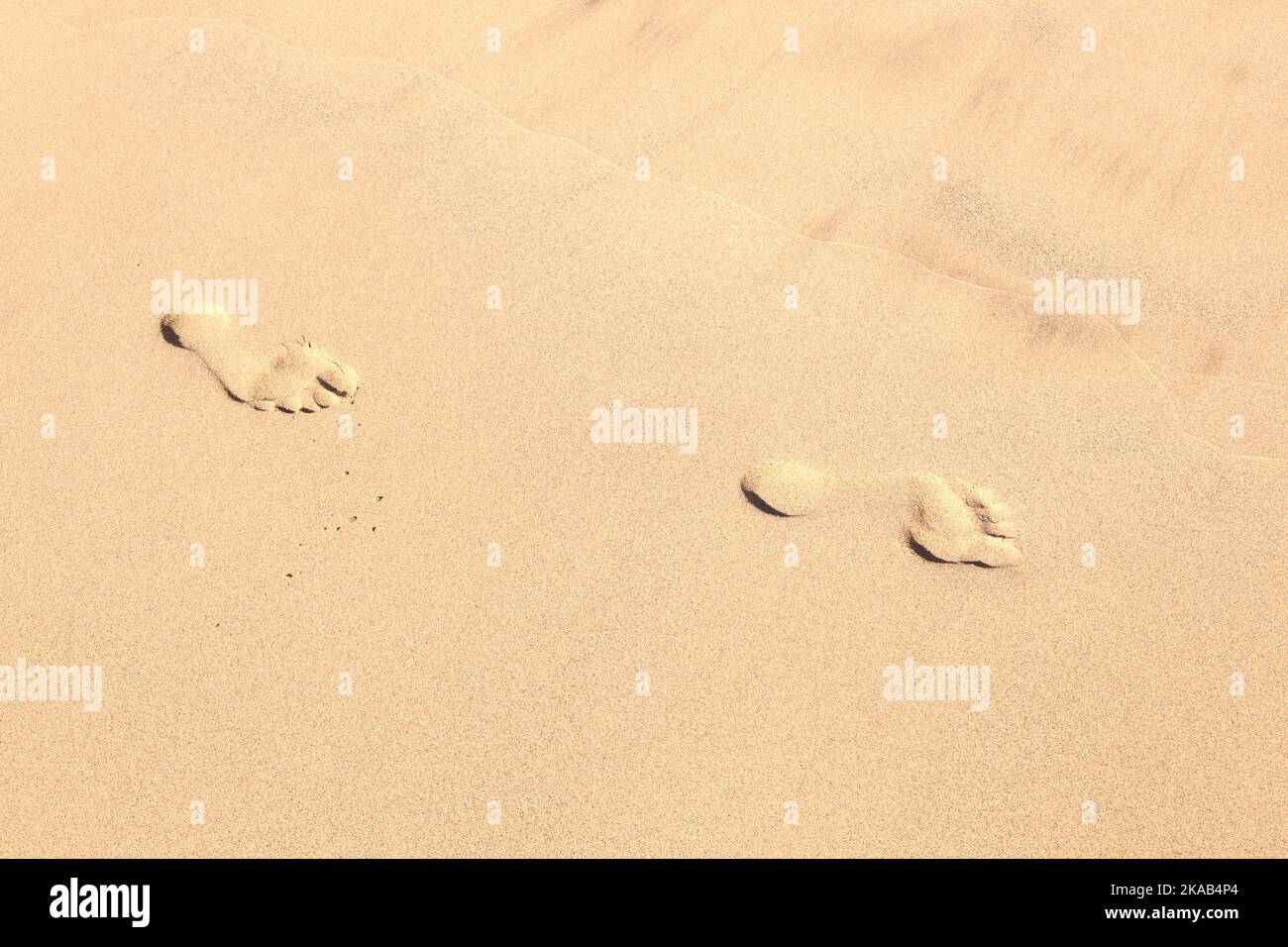 human footsteps at the clean sandy beach Stock Photo - Alamy