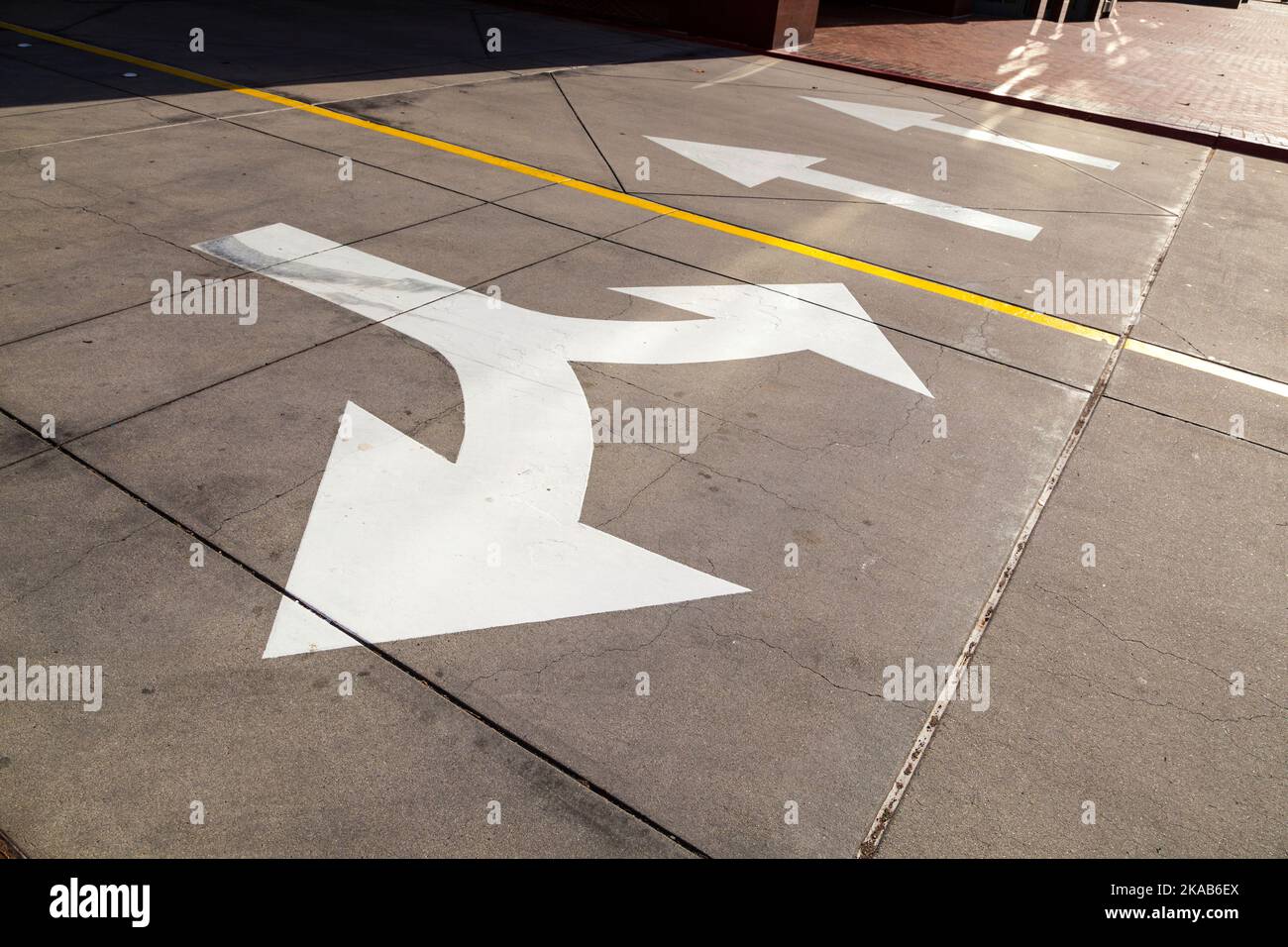 arrows and lines on the asphalt to indicate the direction of driving ...
