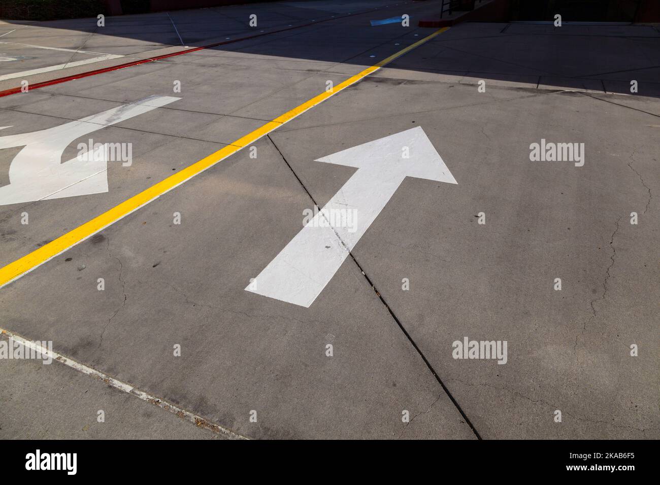 arrows and lines on the asphalt to indicate the direction of driving ...