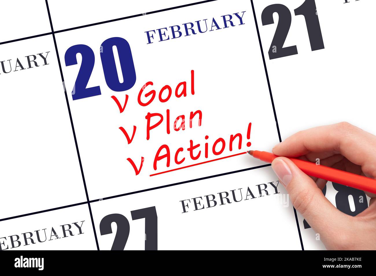 20th day of February. Hand writing text GOAL PLAN ACTION on calendar ...