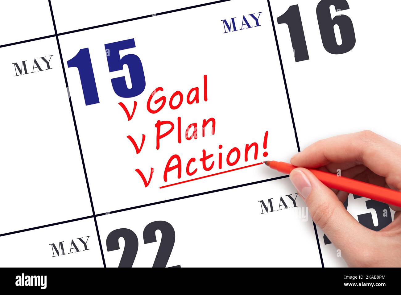 15th day of May. Hand writing text GOAL PLAN ACTION on calendar date ...