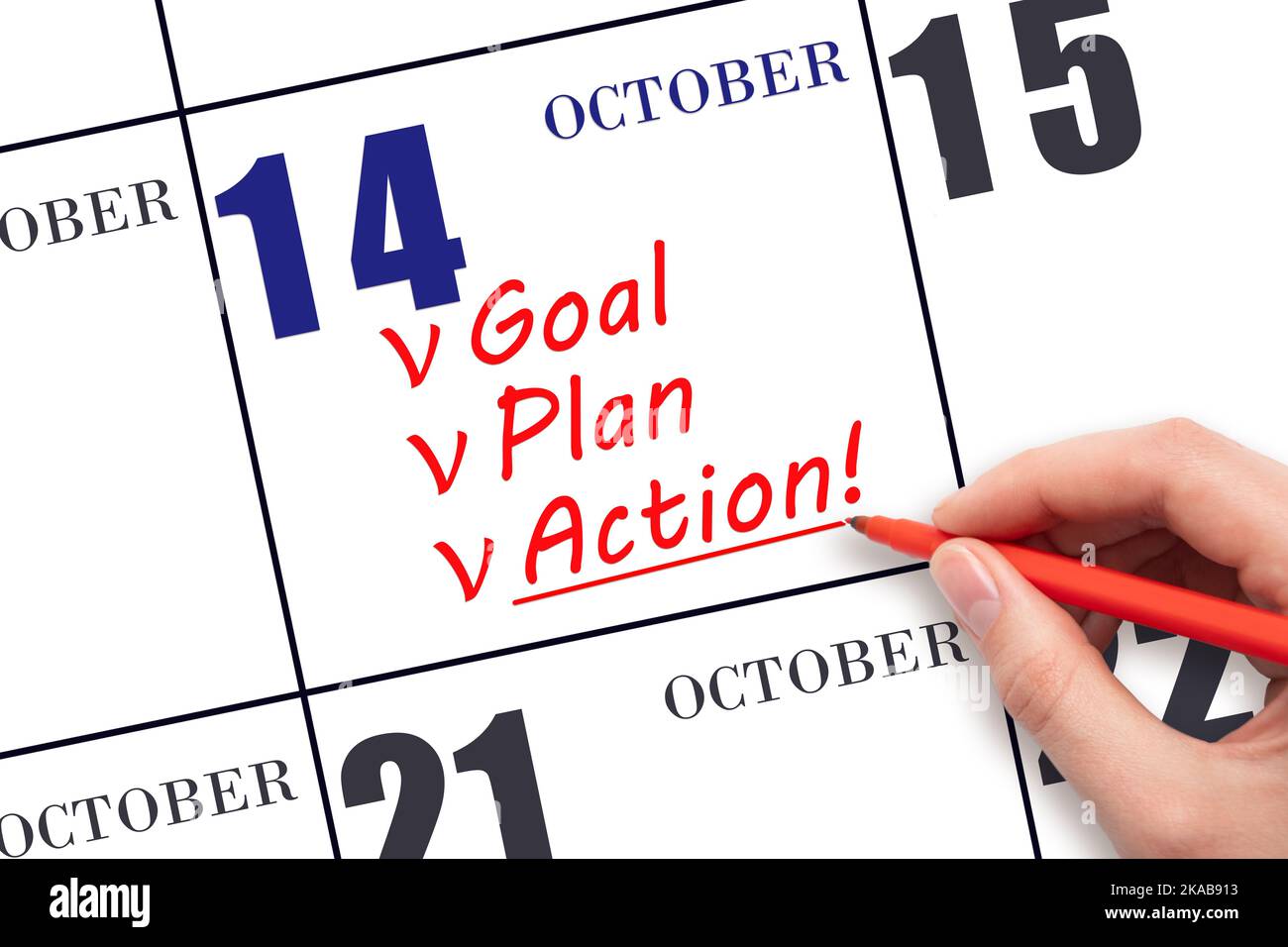 14th day of October. Hand writing text GOAL PLAN ACTION on calendar ...