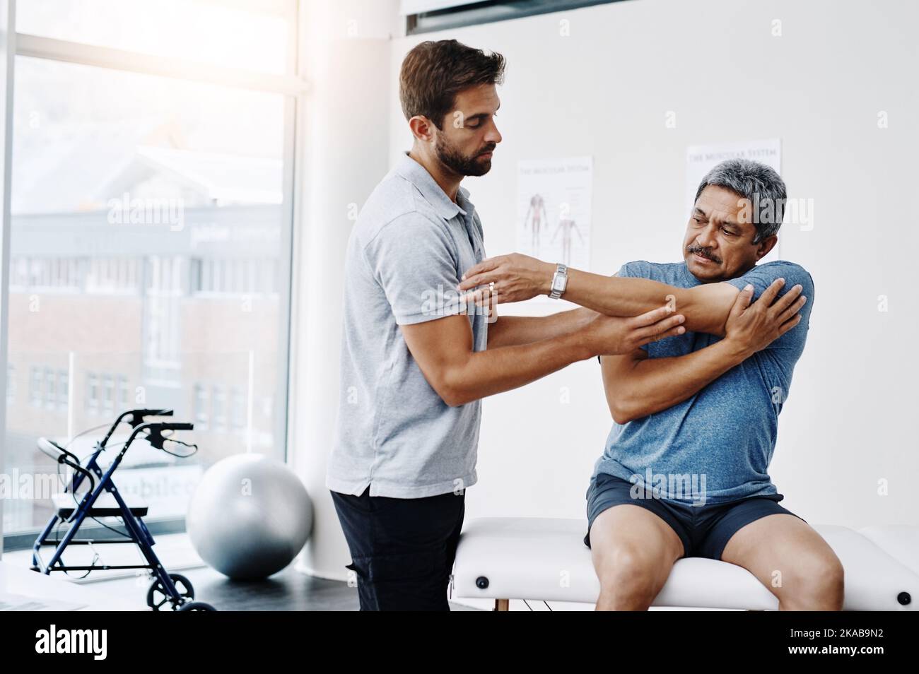 That shoulder still giving you issues. a young male physiotherapist ...