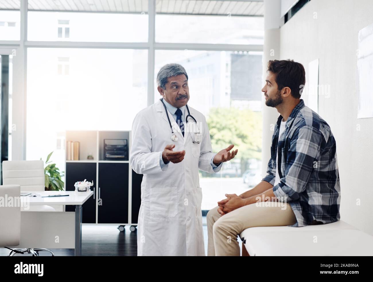Can you tell me more about your symptoms. a mature male doctor and ...