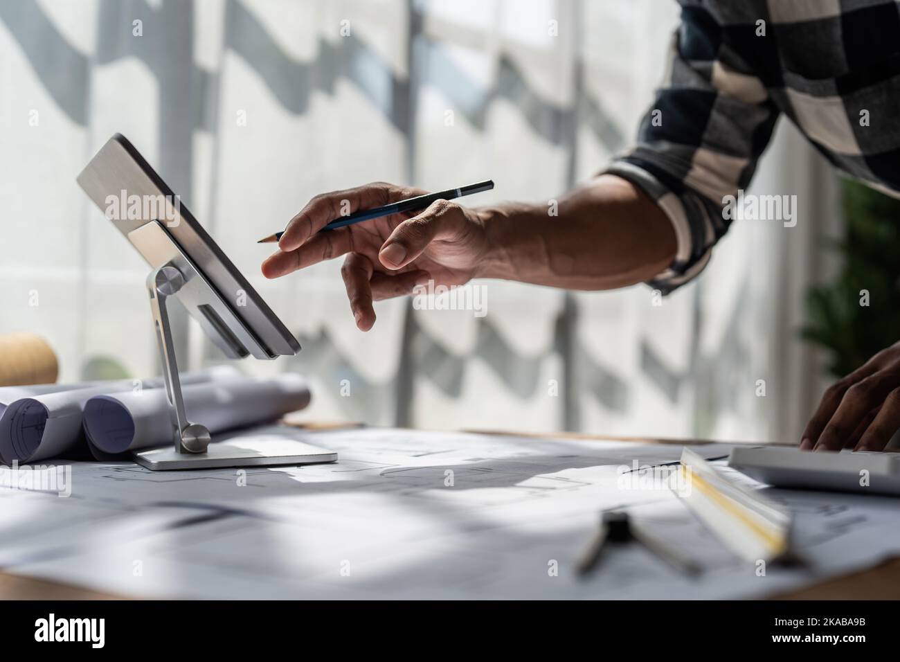 Architect man working with blueprints for architectural plan, engineer ...