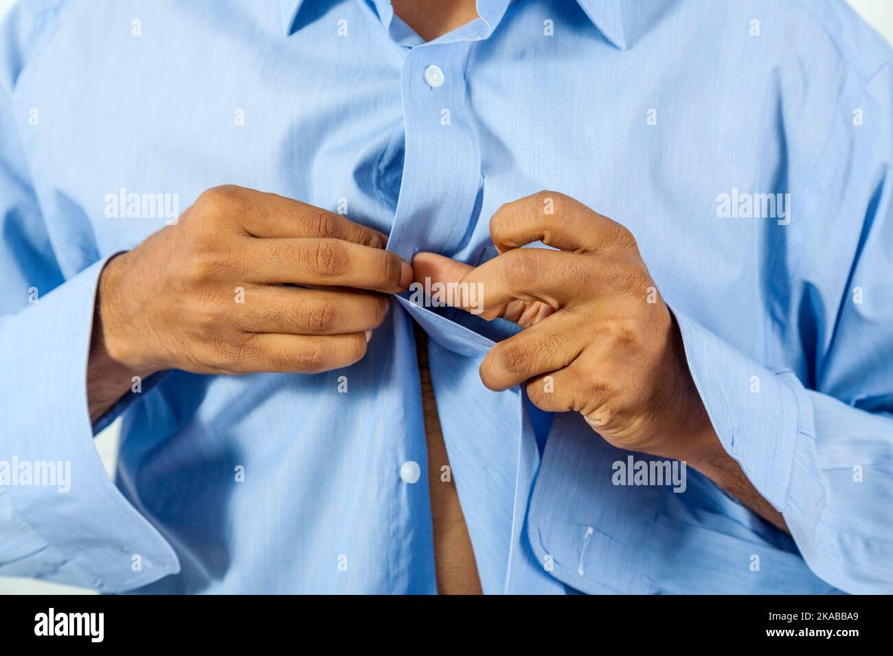 man buttoning his shirt Stock Photo - Alamy