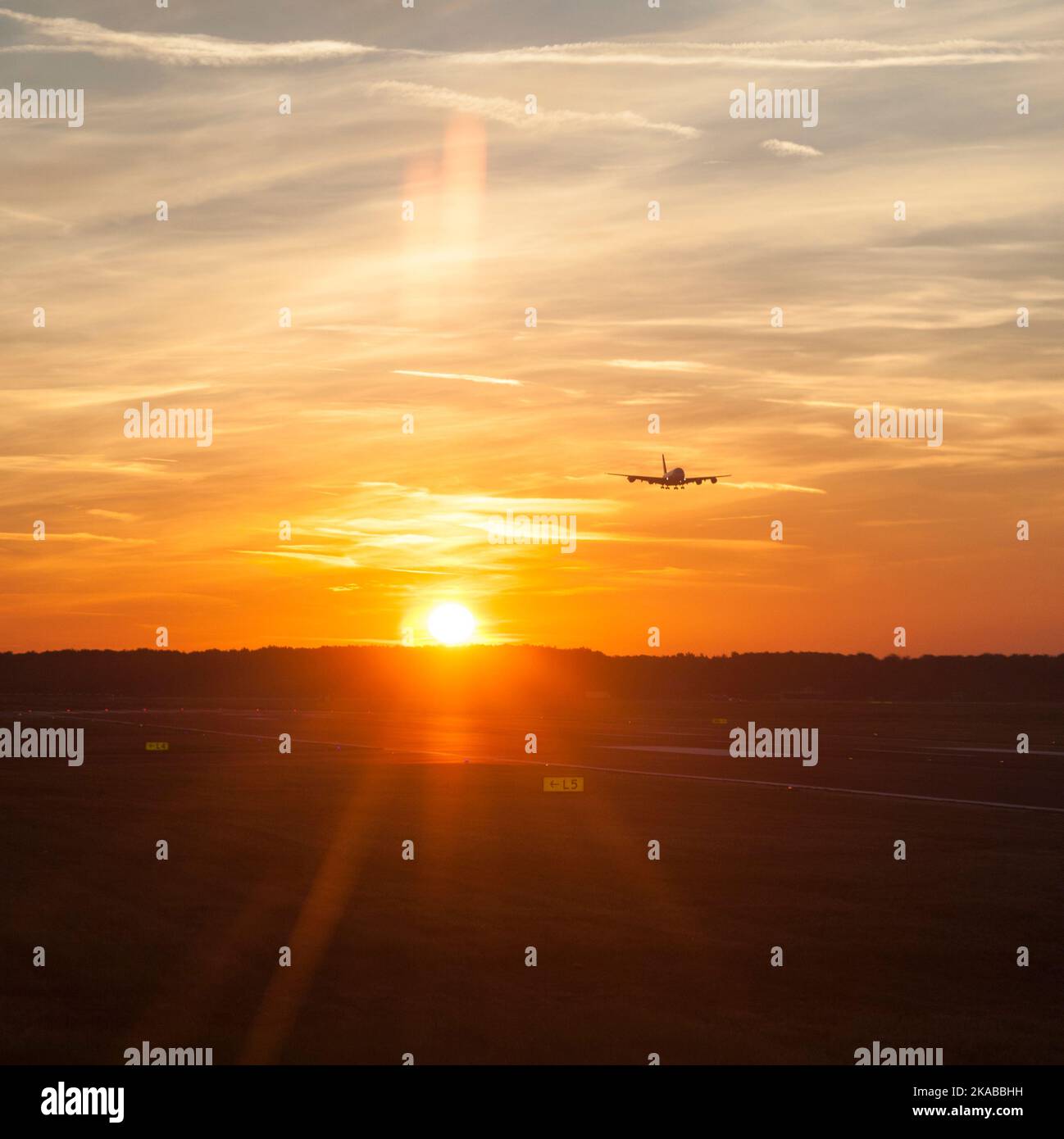 aircraft landing in sunset with colorful sky Stock Photo - Alamy
