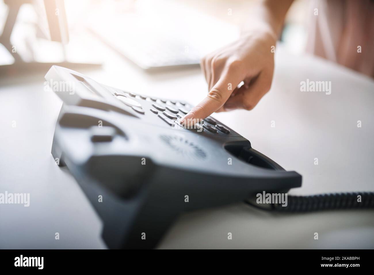 Dial those digits. an unrecognizable businesswoman using the landline ...