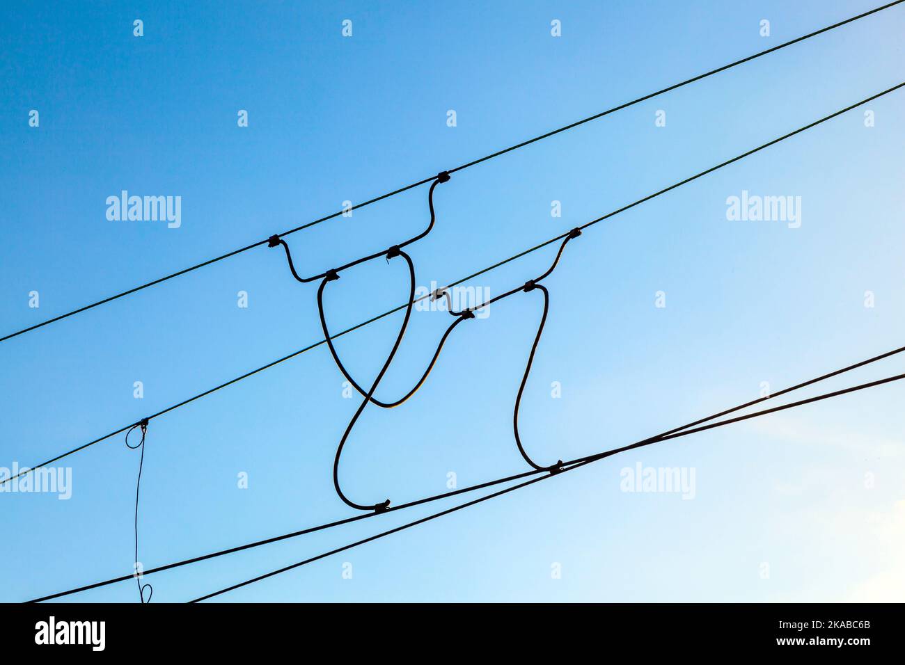 Railroad overhead lines against clear blue sky, Contact wire Stock ...