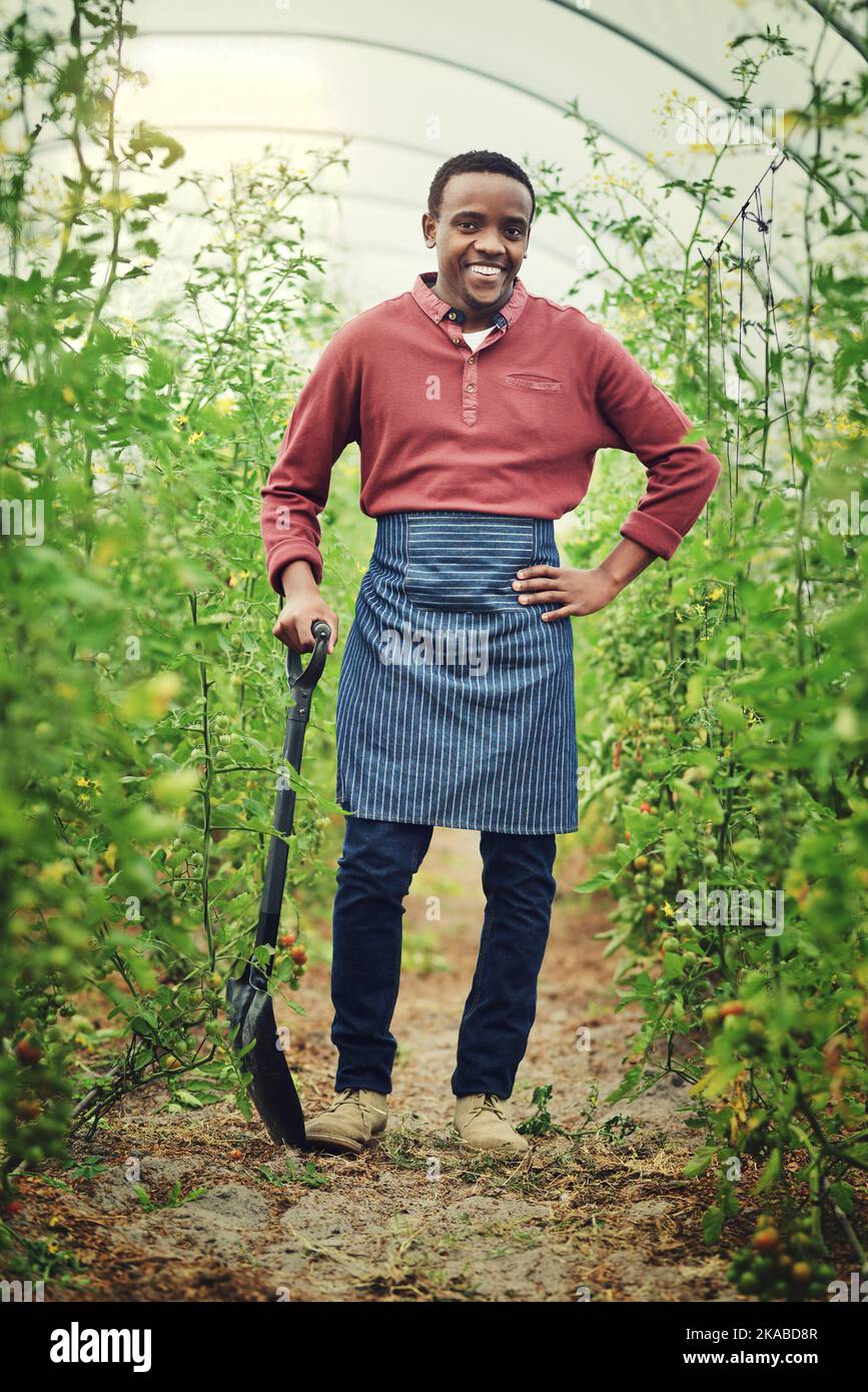 I enjoy working for my food. young farmers tending to their crops Stock ...