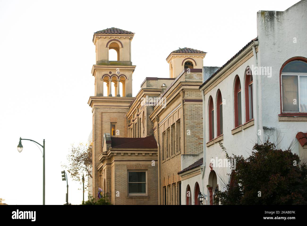 Late afternoon sun shines on the historic church and downtown of the bay area city of Alameda ...