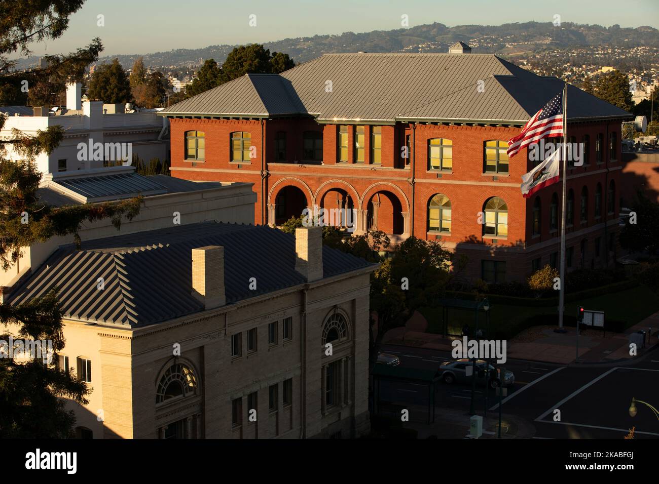 Late afternoon sun shines on the historic bay area city of downtown Alameda, California, USA ...