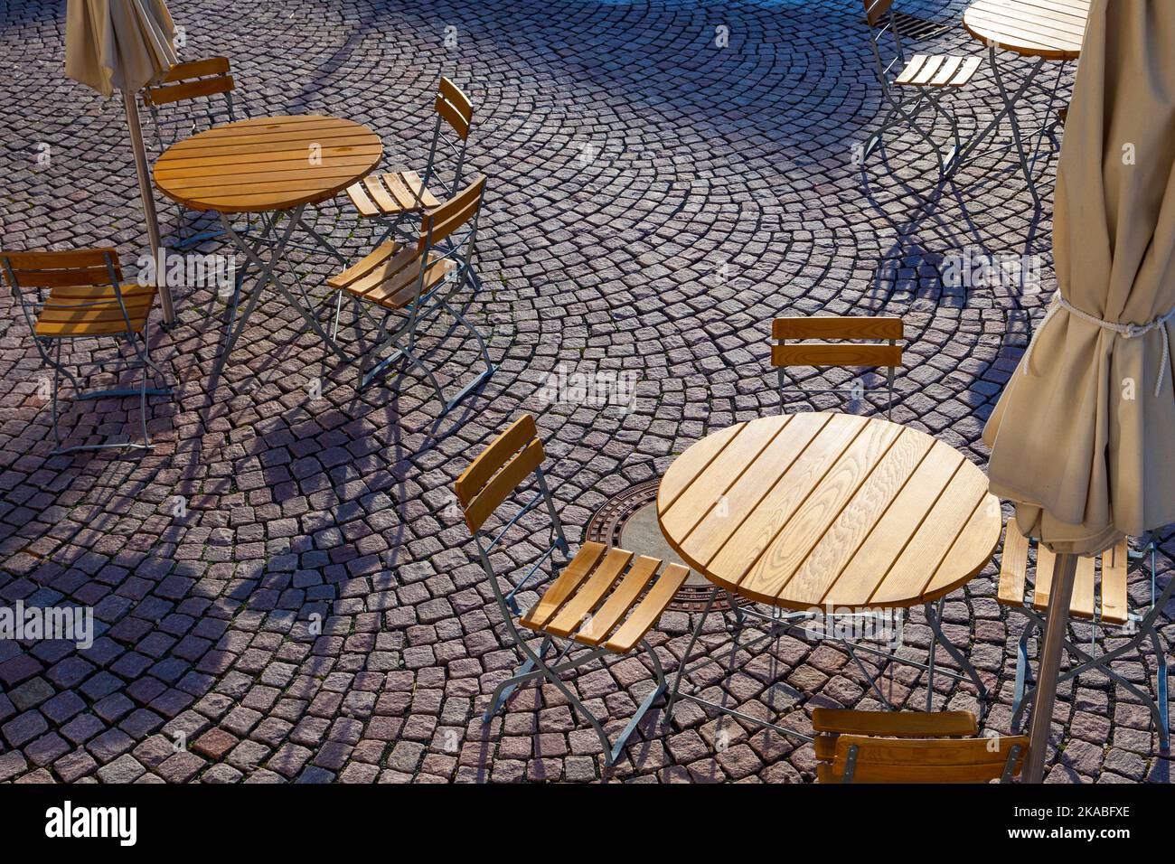 Outdoor German cafe seating with round tables and wooden chairs Stock ...