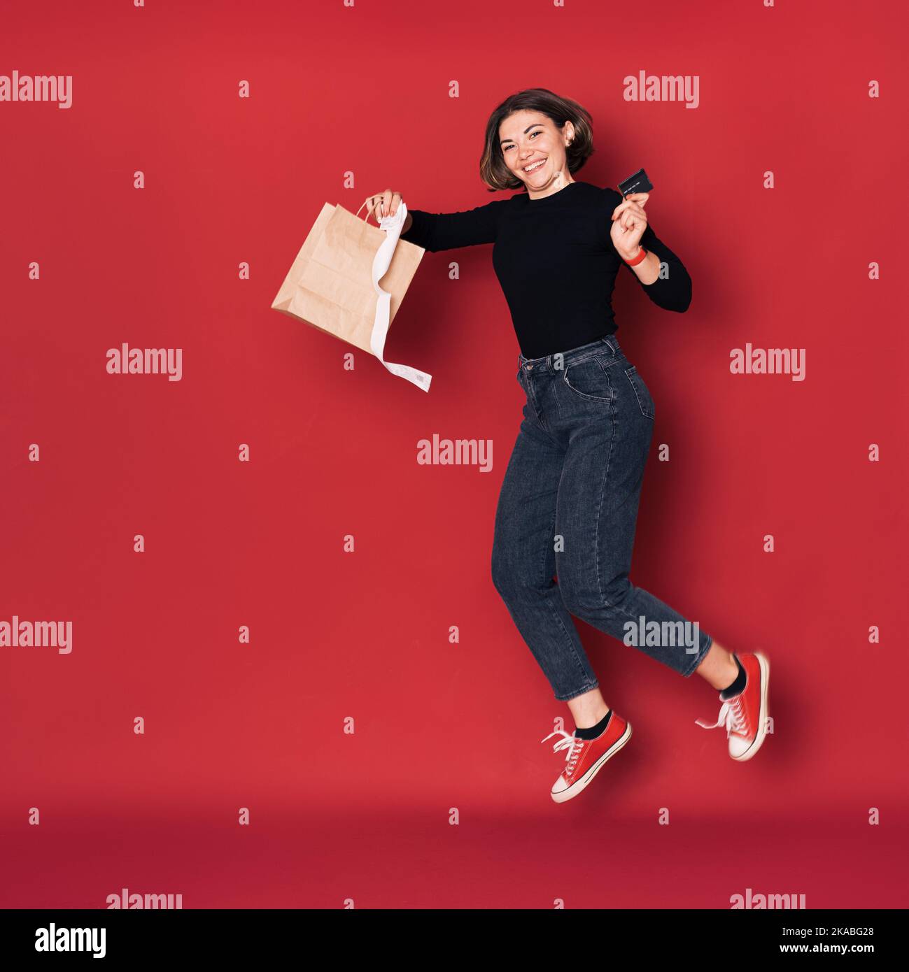 Lady holding credit card with check and paper bag Stock Photo - Alamy