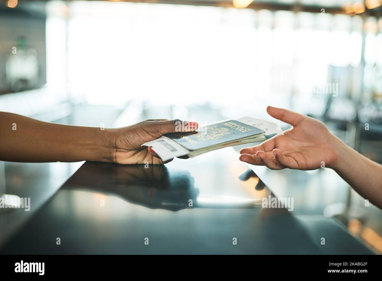 Her travel documents are in order. an unrecognizable woman handing over ...