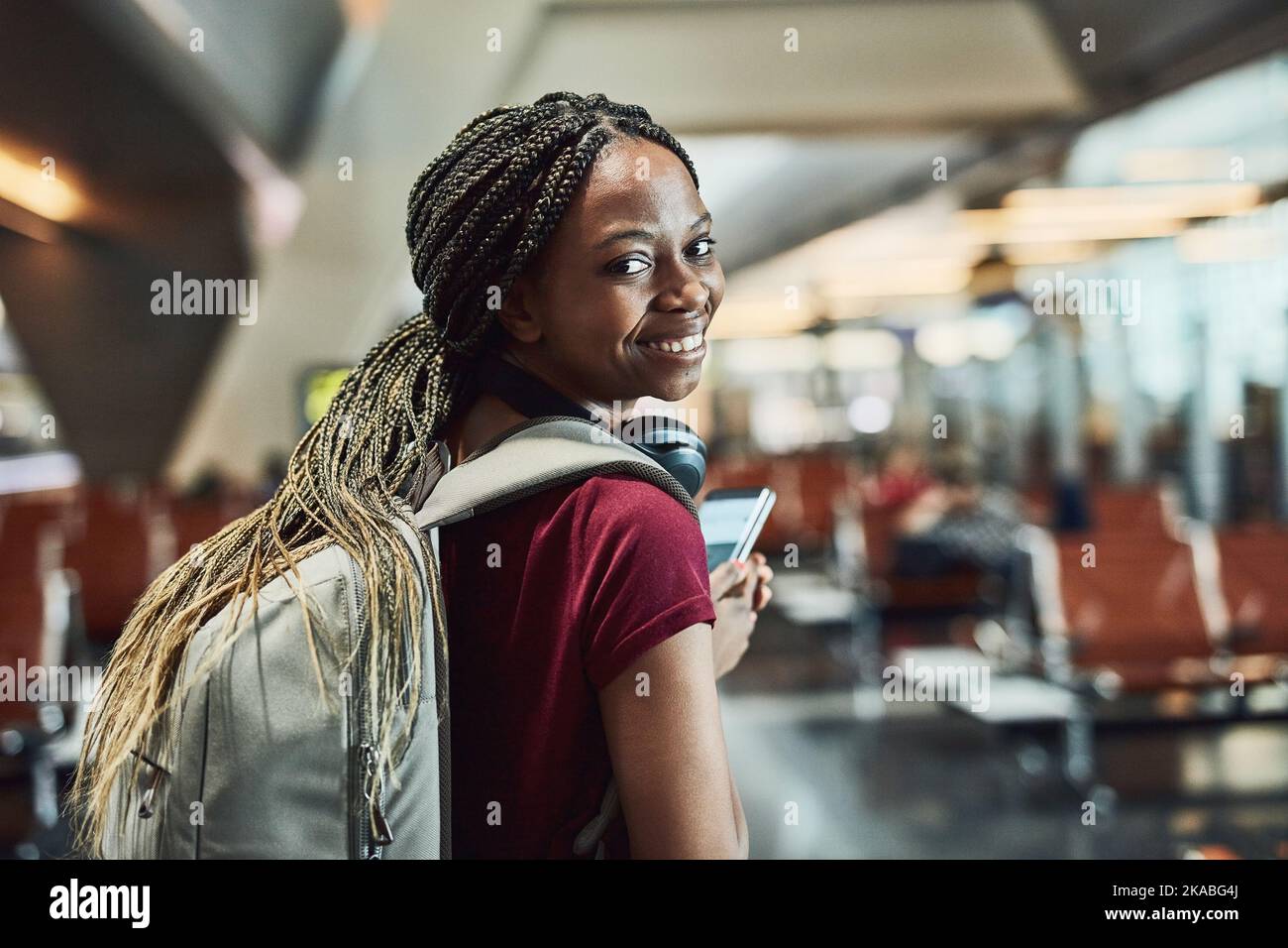 I travel light. a happy young woman at the airport Stock Photo - Alamy