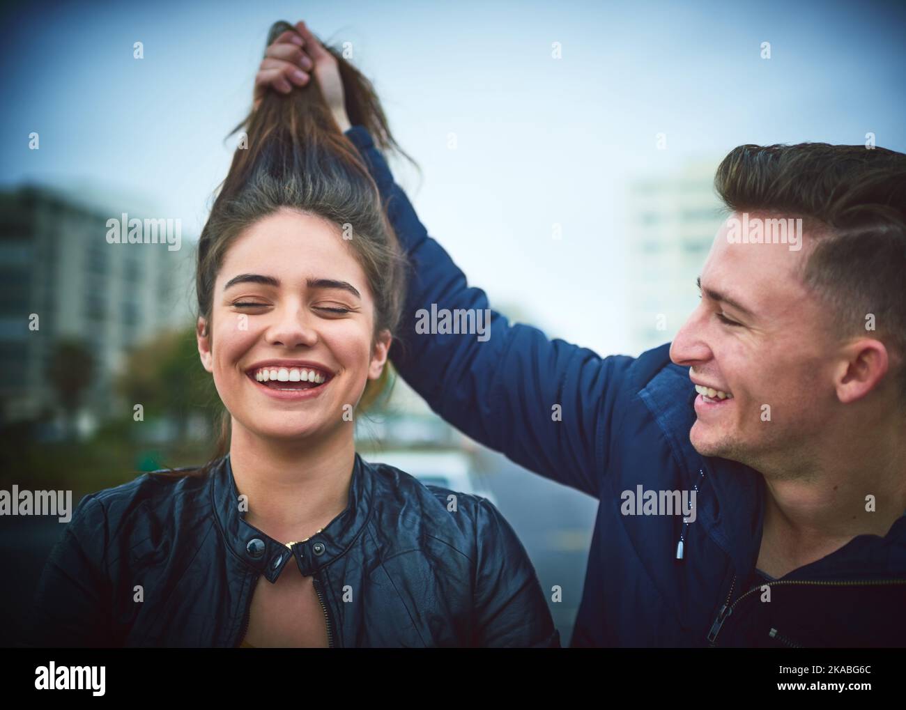 Its All Fun And Games With These Two A Young Man Playfully Pulling His Girlfriends Hair