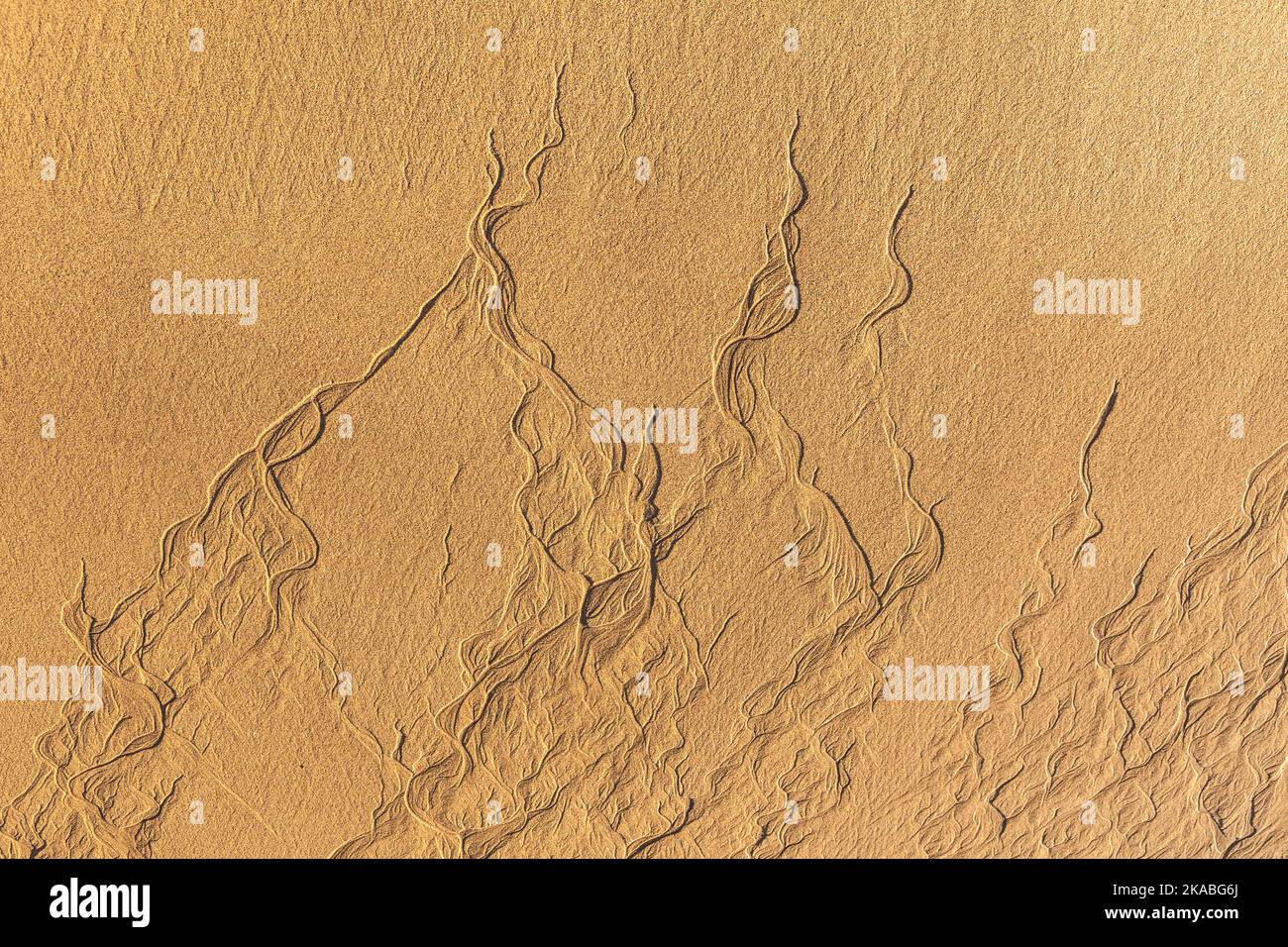 islamic pattern type texture on the sand beach while low tide time ...