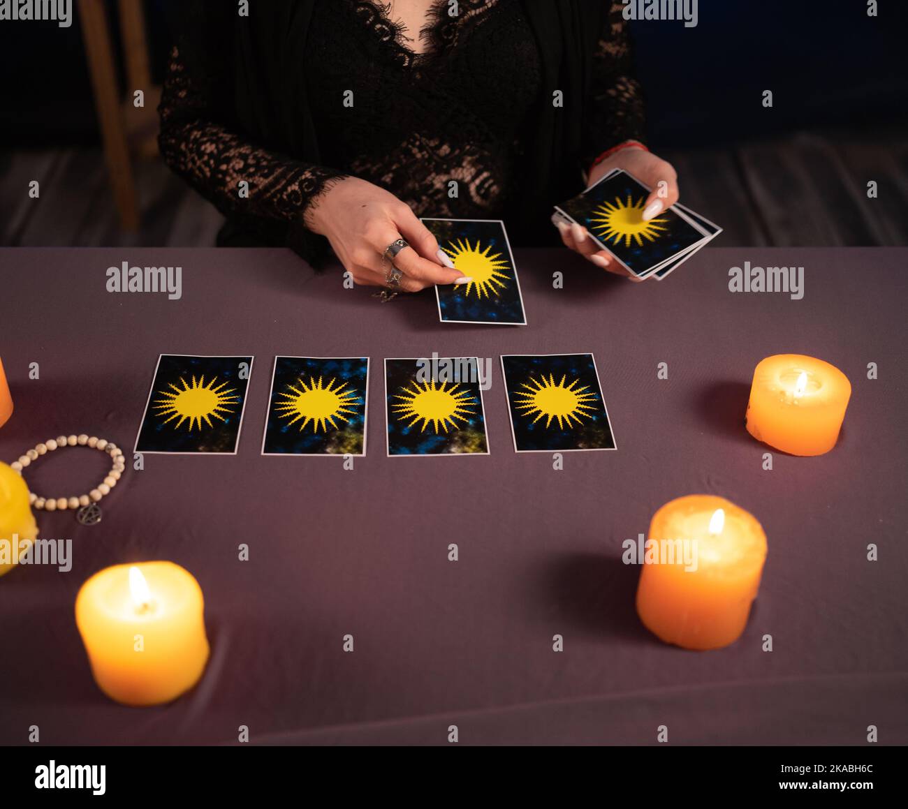 Fortune teller hands and tarot cards on wooden table. Divination Stock ...