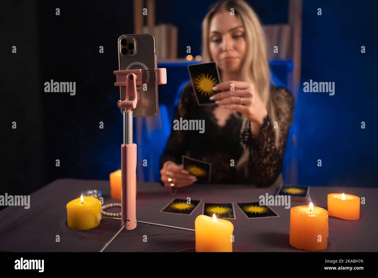 Online astrology. The fortune teller is use a smartphone, reads tarot ...