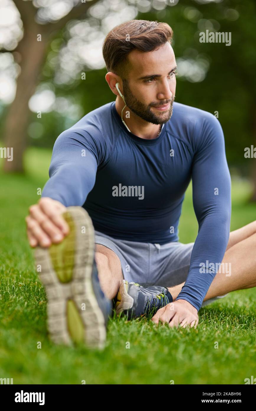 Stretching is just as important as the workout. a handsome young male ...