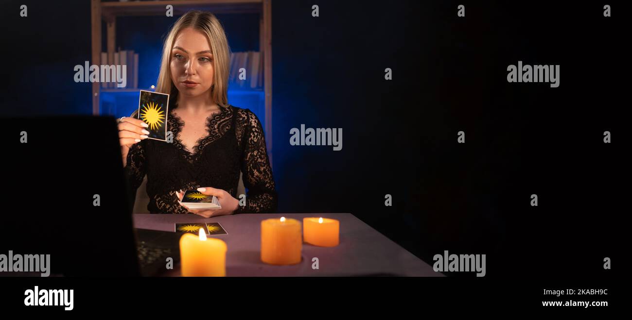 Modern technology. professional female fortune teller holding a tarot ...