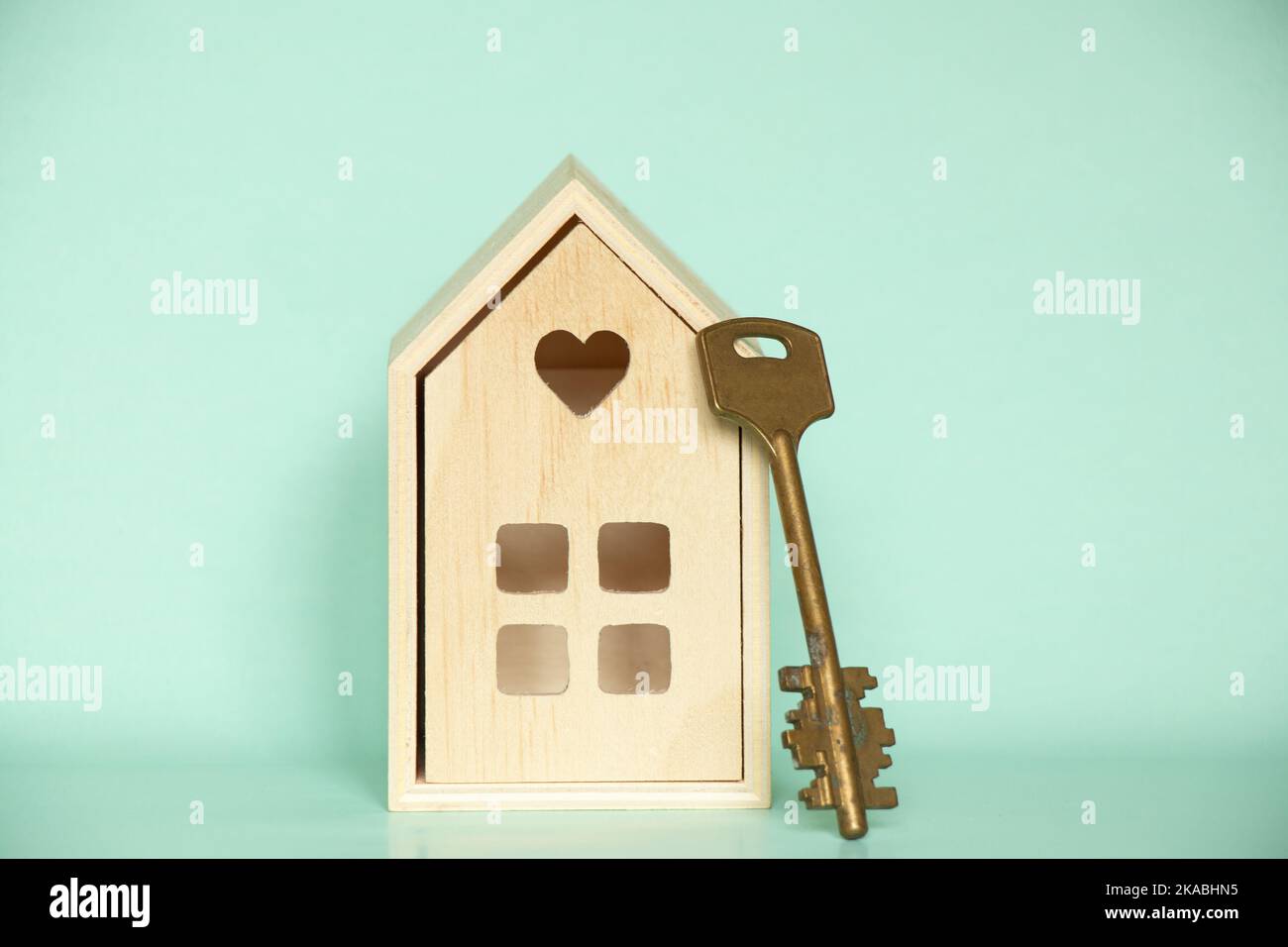 Small wooden house and door lock key on isolated background ,buying a ...