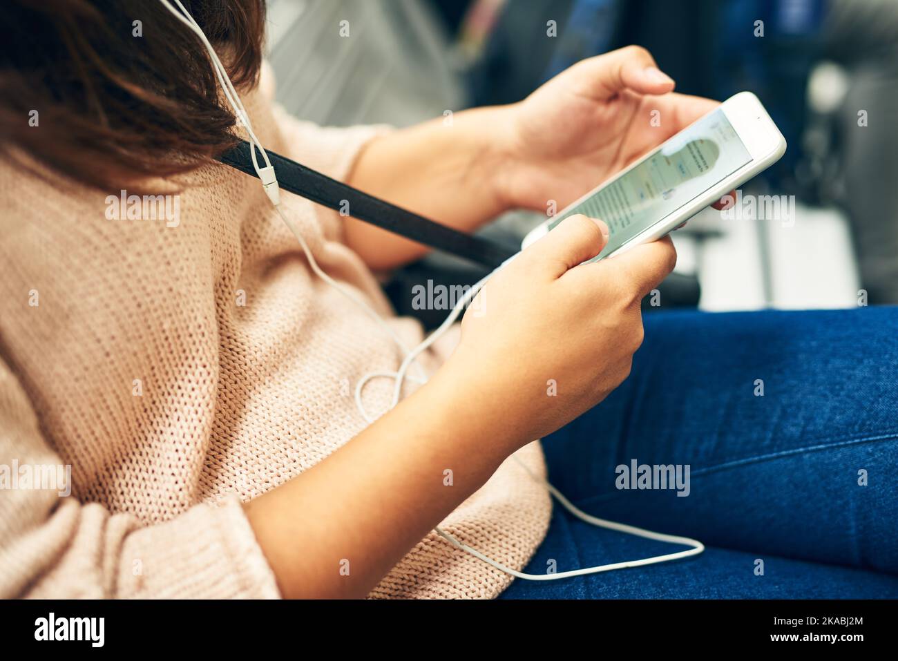 Passing the time. High angle shot of an unrecognizable young woman ...