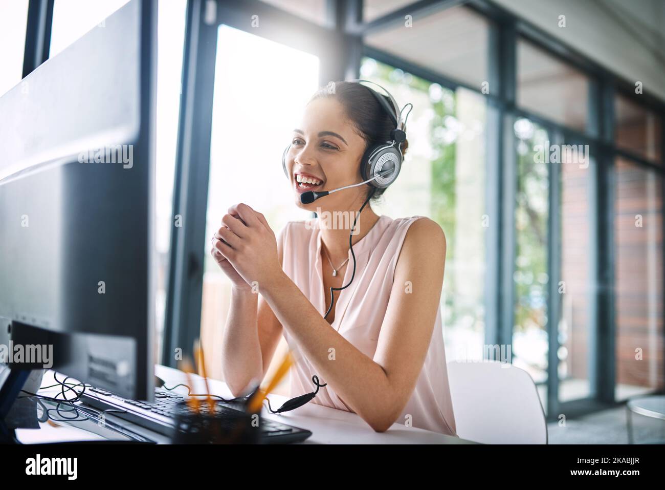 Please hold while I connect your call. an attractive young woman ...