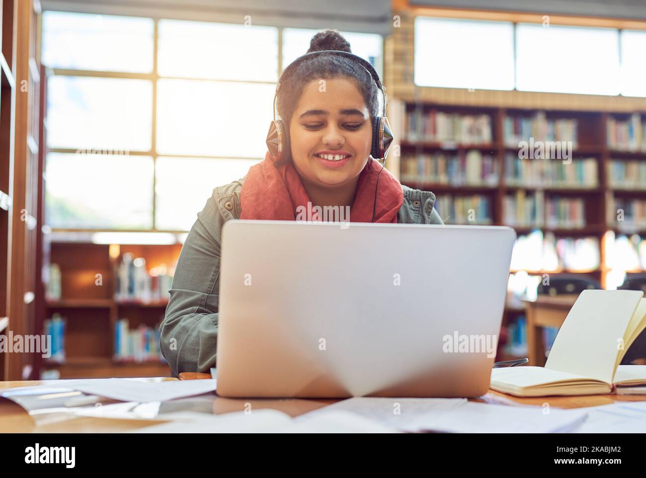 She goes in study mode once she puts her headphones on. a cheerful ...