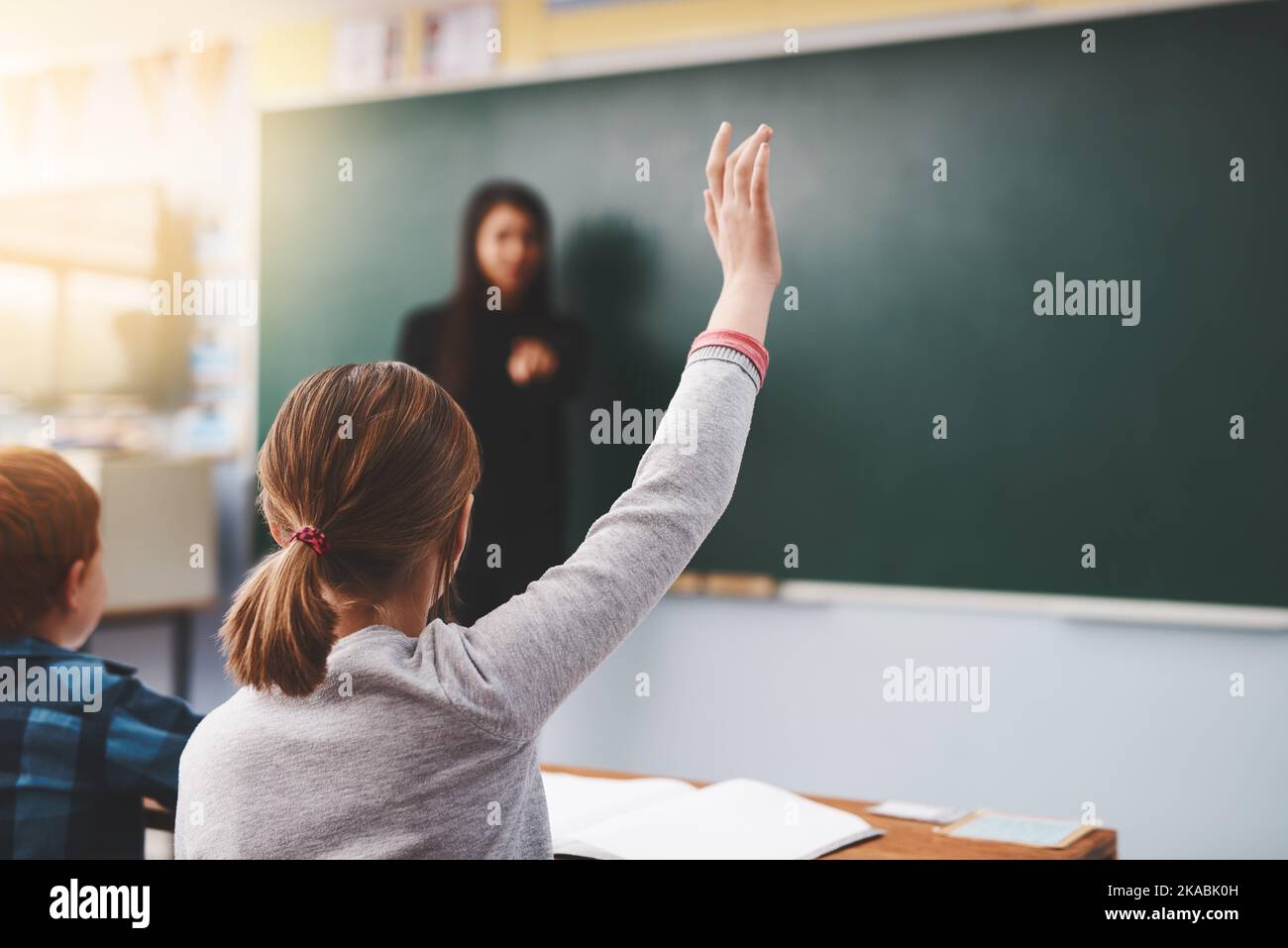 I will anser all your questions. elementary school children raising their hands to ask questions ...