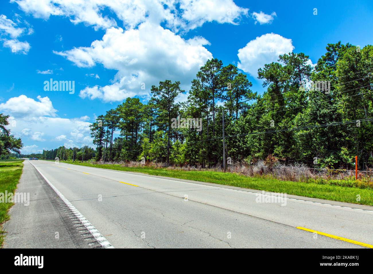empty highway in america with trees and blue sky - travel symbol Stock ...