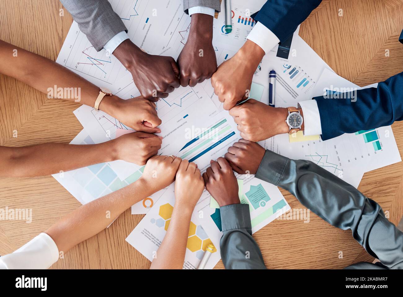 Teamwork, documents and circle of hands in fist in business meeting for strategy, planning and ...
