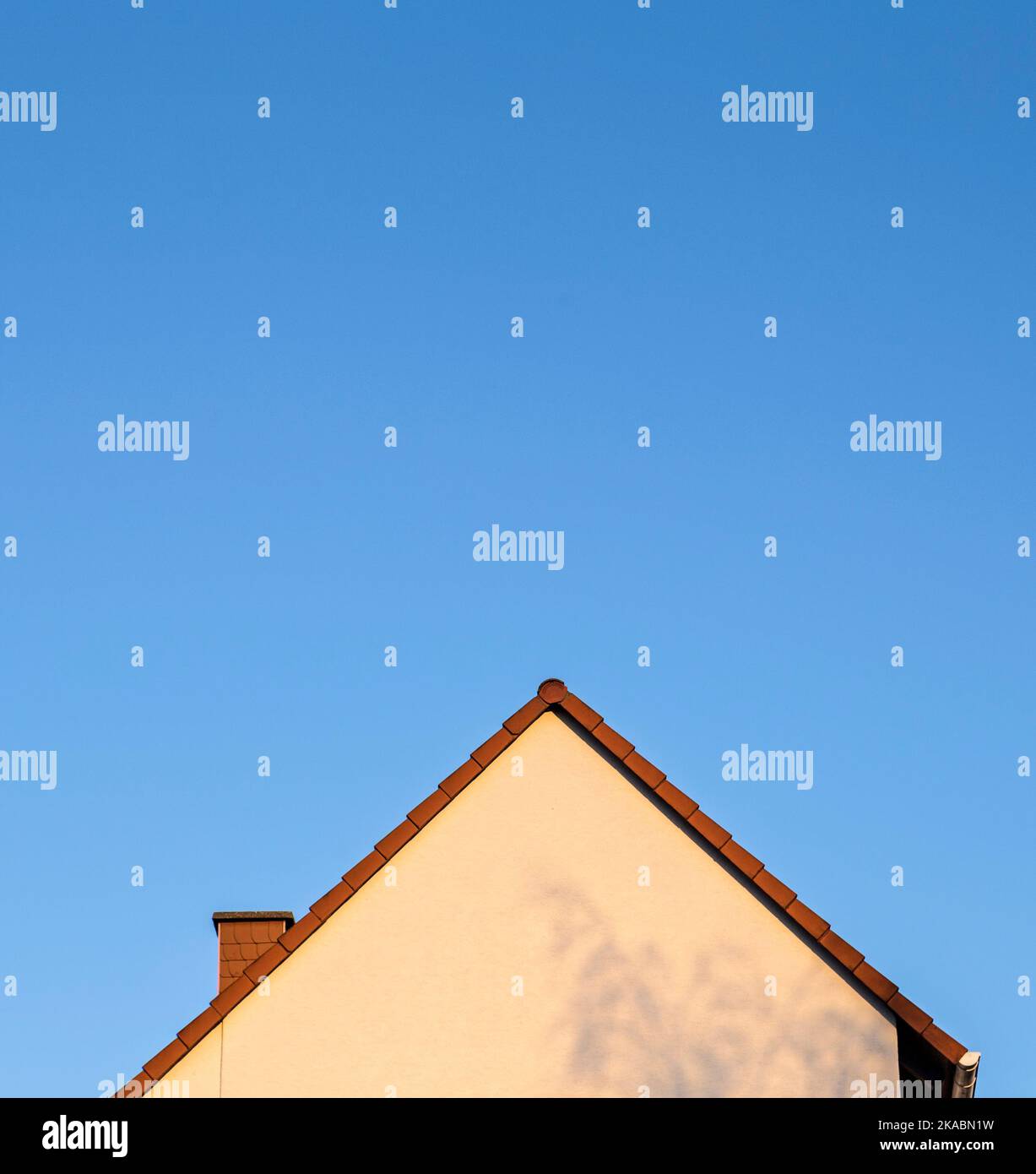 house facade with gable and roof pattern under blue sky Stock Photo - Alamy