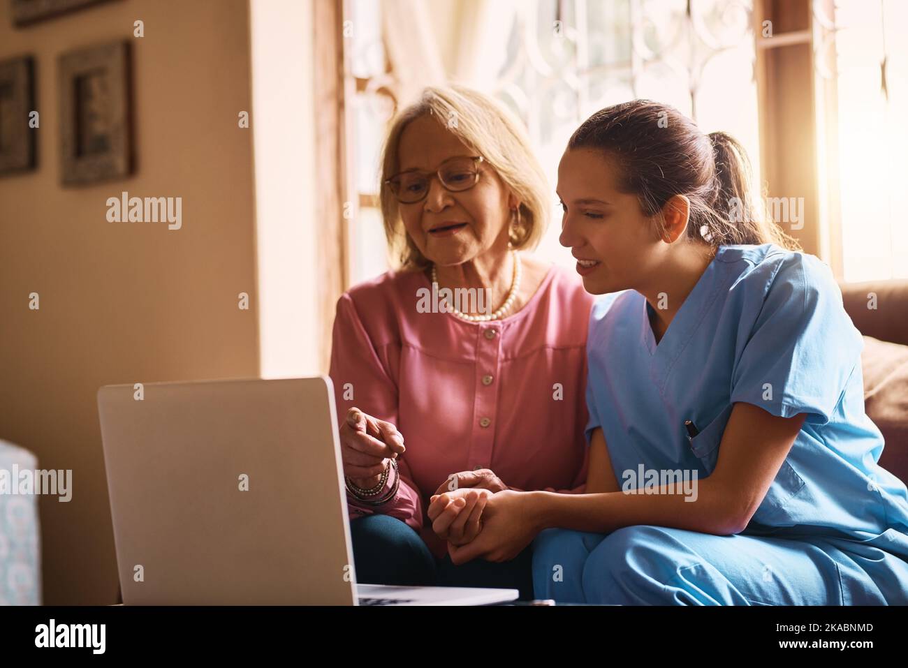 Showing her how easy it is to stay connected. a female nurse and a ...