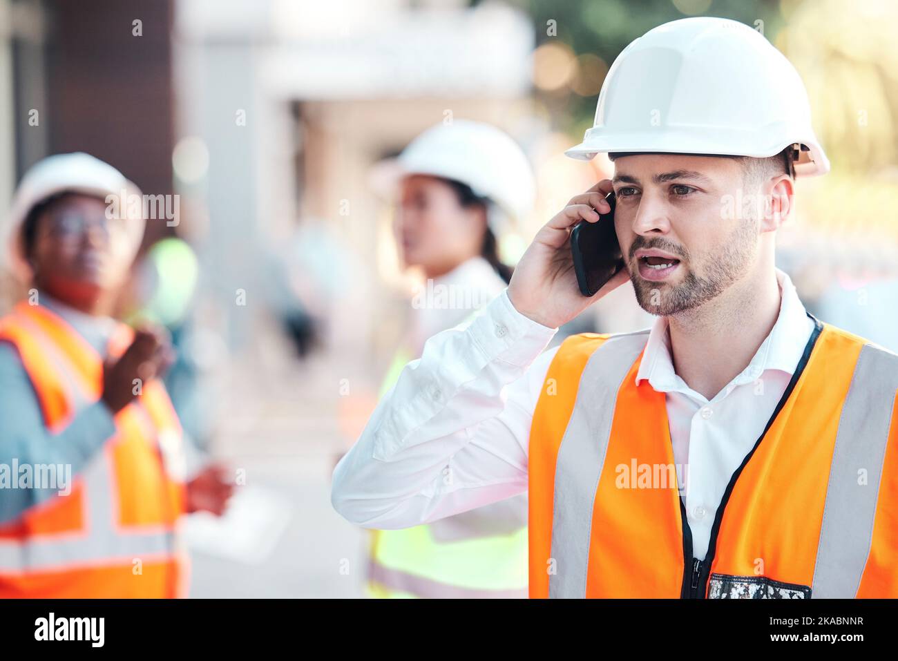 Engineer, phone call on site and man for construction, confirm building ...