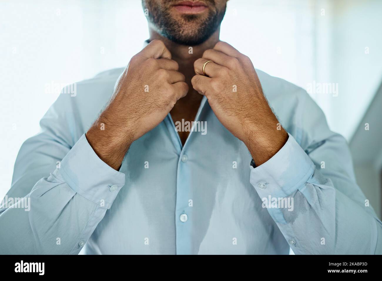 This shirt is making me hot and sweaty. an unrecognizable man dressing ...