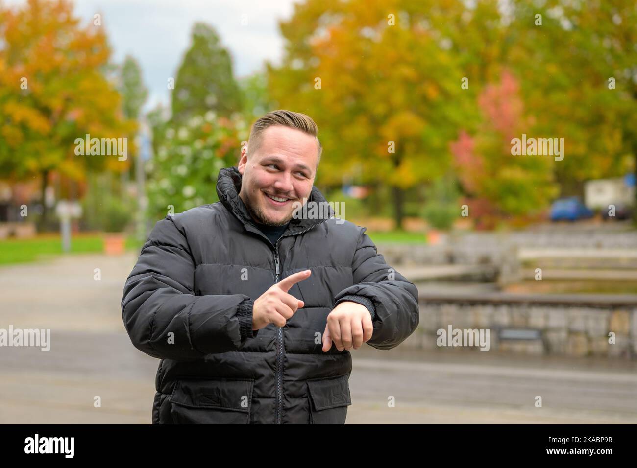 Young man looks to someone with a smiling and challenging smile and ...
