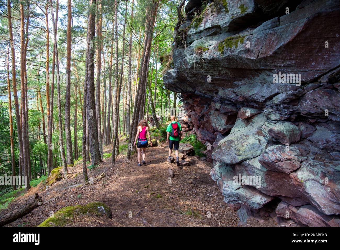 Hikers in the Dahner Felsenland (Germany). The many rock formations of ...
