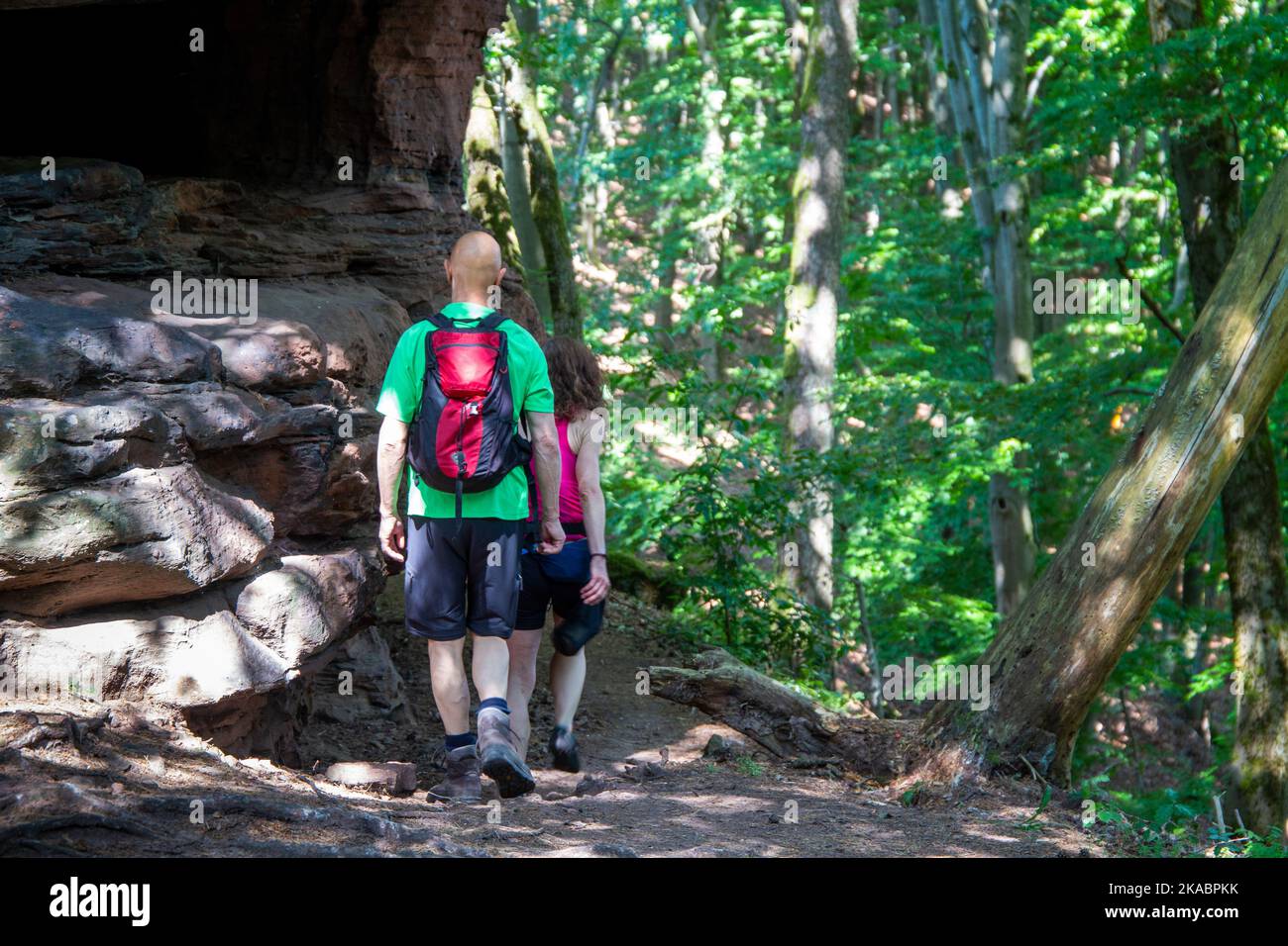 Hikers in the Dahner Felsenland (Germany). The many rock formations of ...