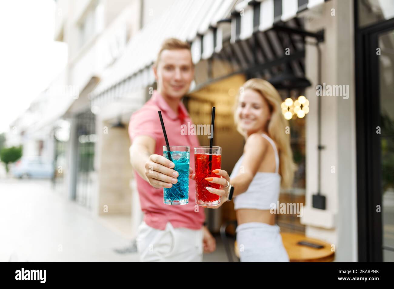 Soft focus young couple outdoor bar ,drinking cocktails or lemonade ...