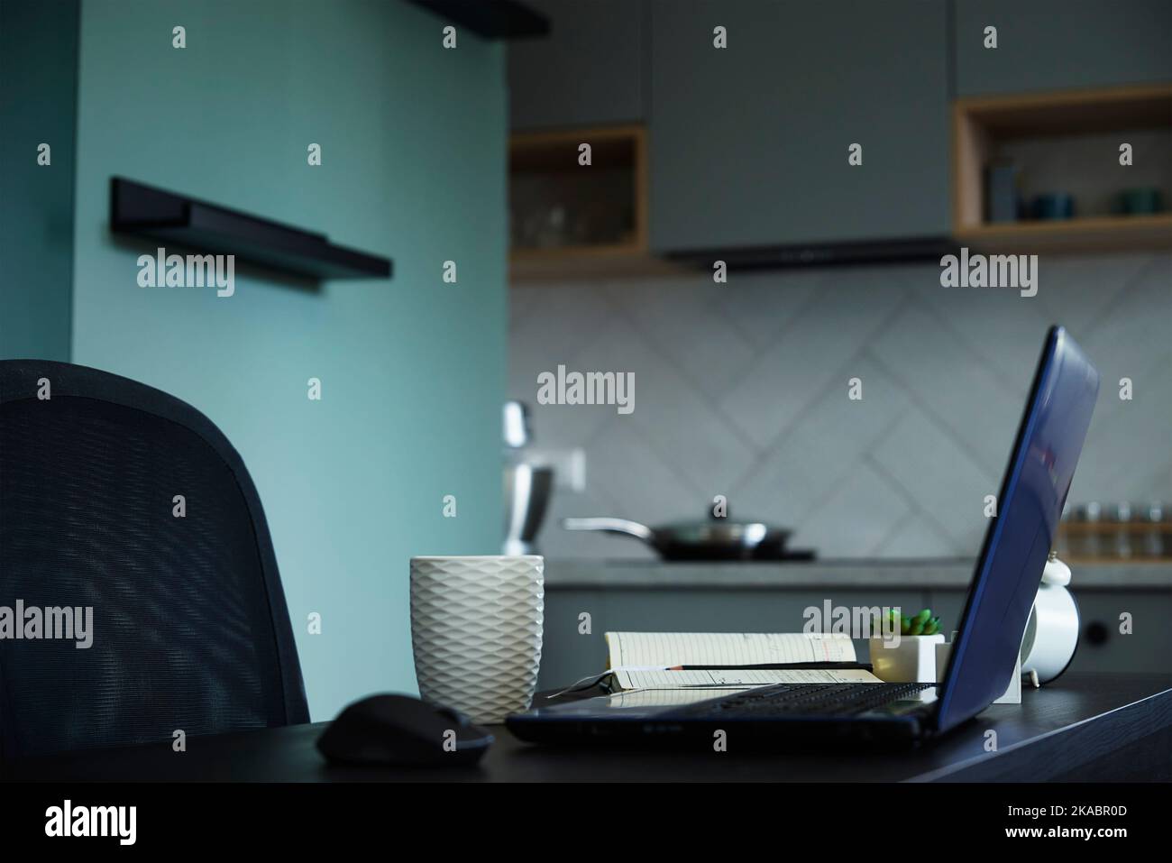 Workplace with table and laptop at the kitchen. Home office and remote ...