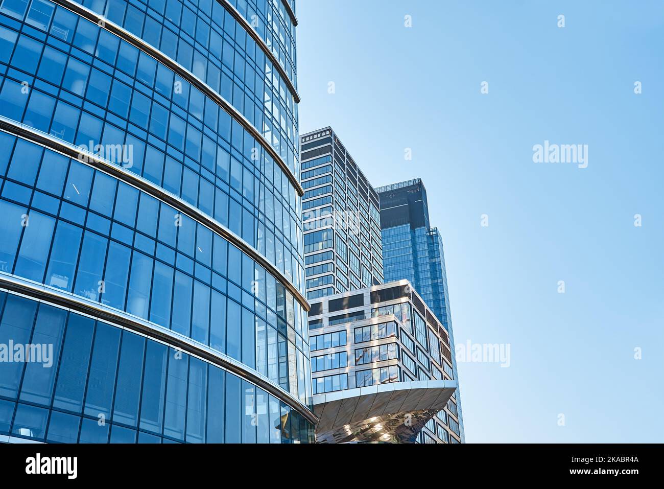 Modern city architecture, Skyscraper glass facade with green tree ...