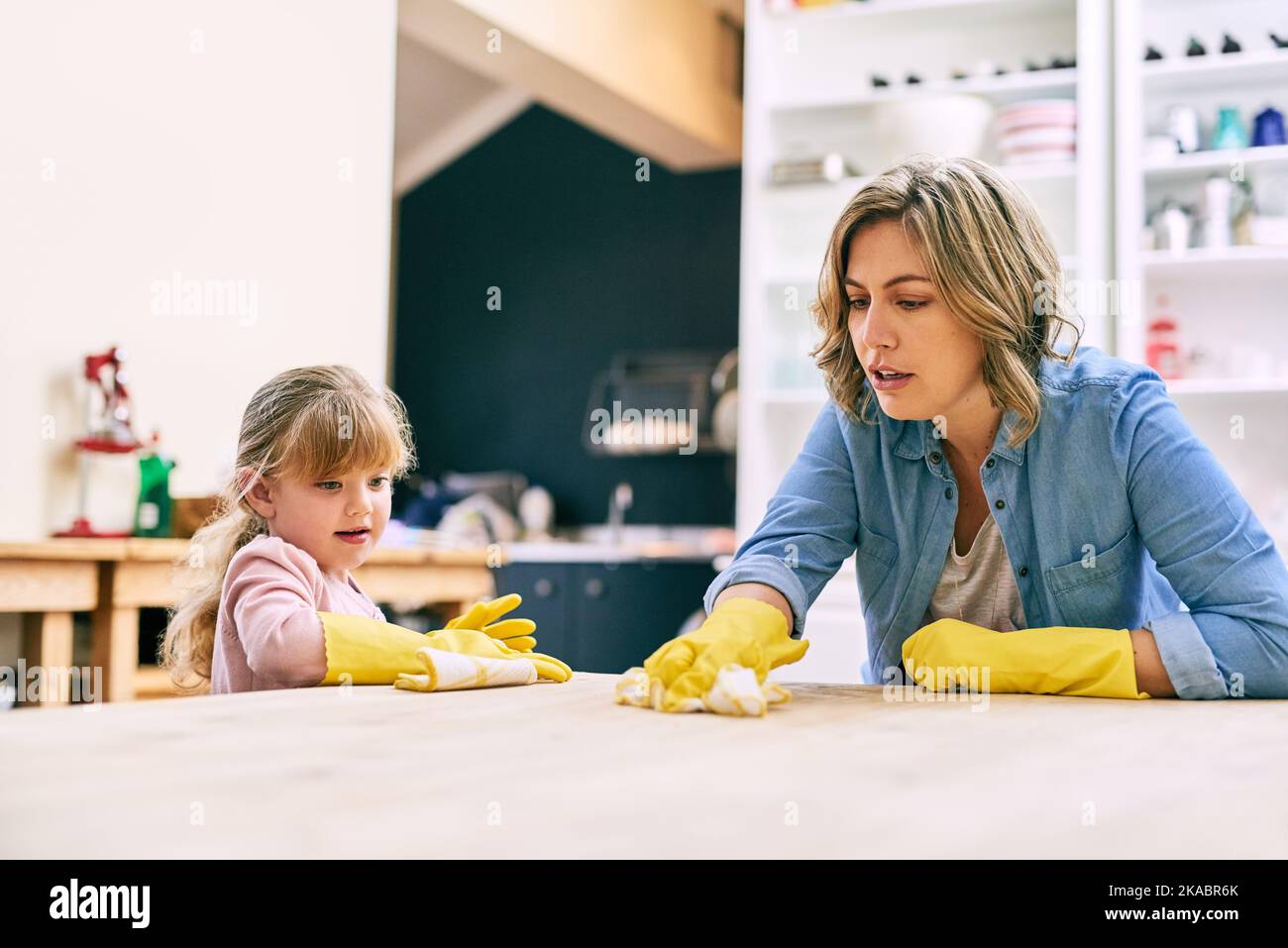 Make sure you reach every part of the table. a determined young mother ...
