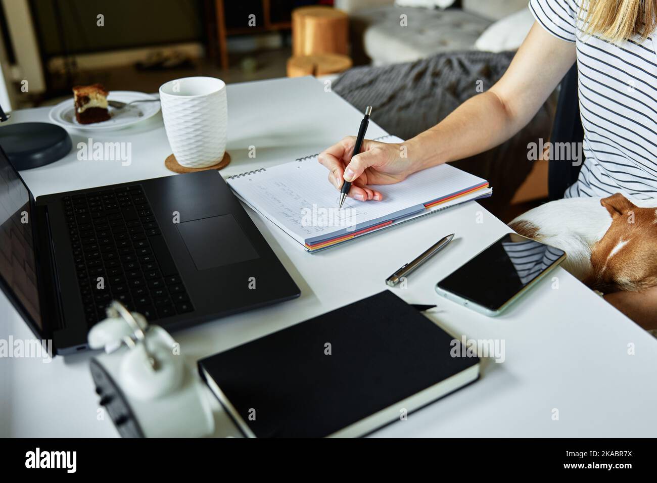 Home office workplace with laptop. Woman working remotely from home, using laptop. Creative ...