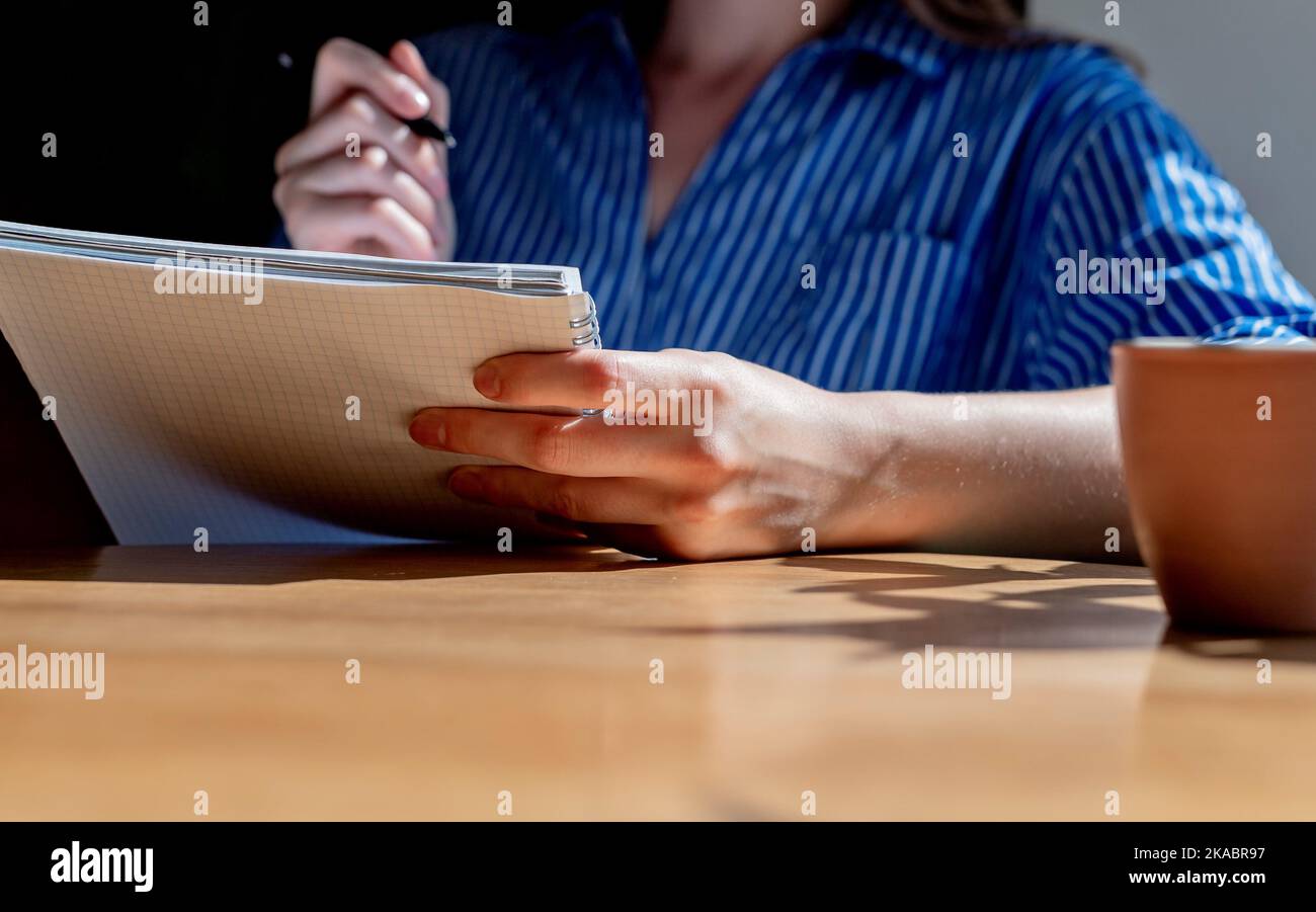 Student hands close up writing with pen in notebook, taking notes in ...