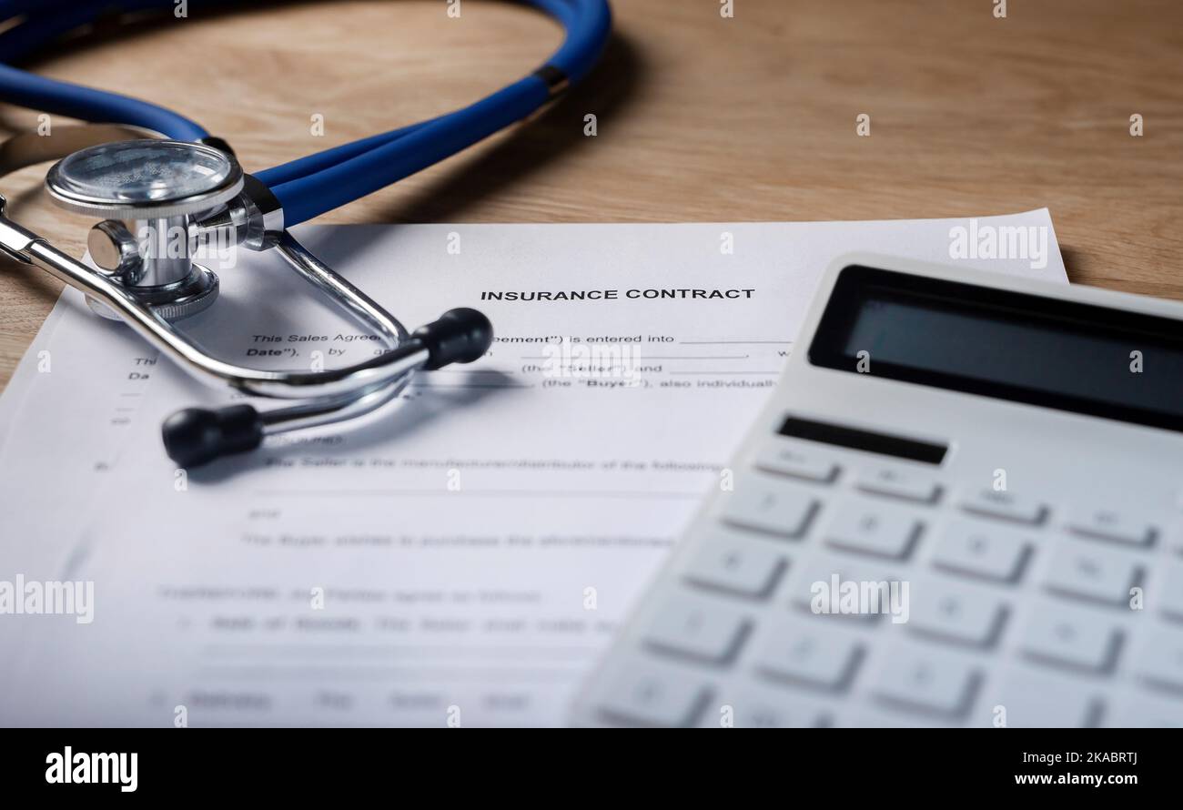 Health insurance concept. Medical contract with stethoscope and ...